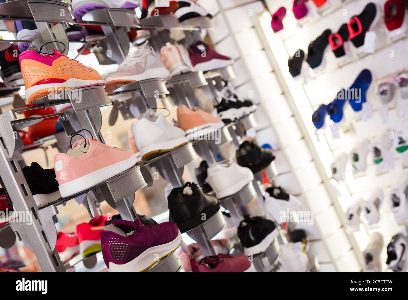 Collection of training shoes on shelves in sports goods store Stock ...