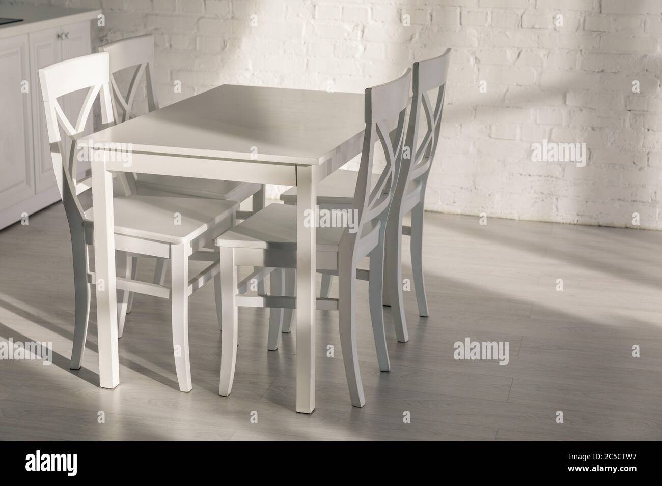 chairs near table and brick wall in modern kitchen Stock Photo - Alamy