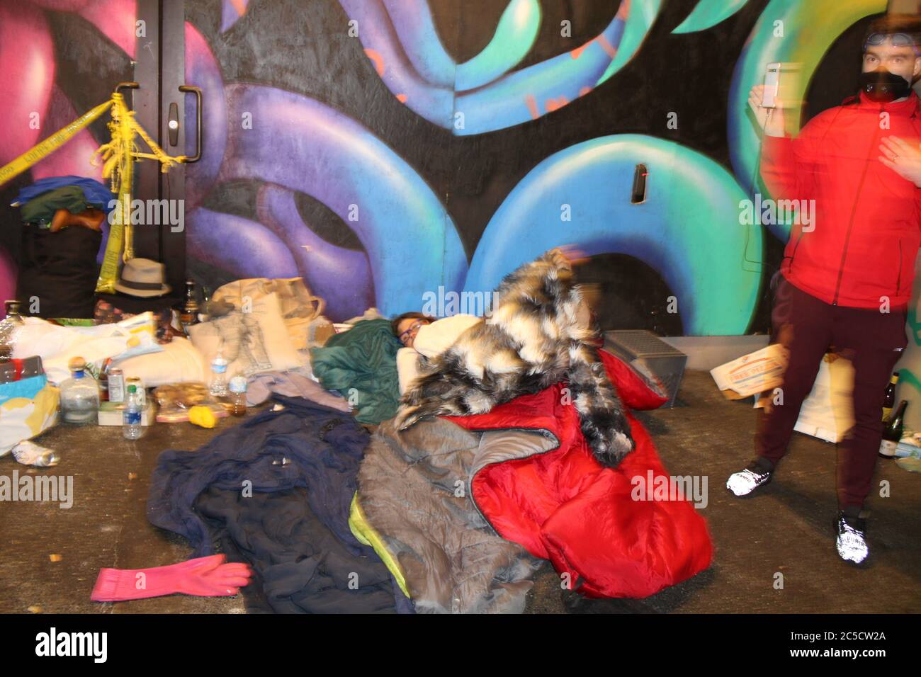 July 2, 2020, Seattle, Washington, U.S: A homeless woman lays next to ...