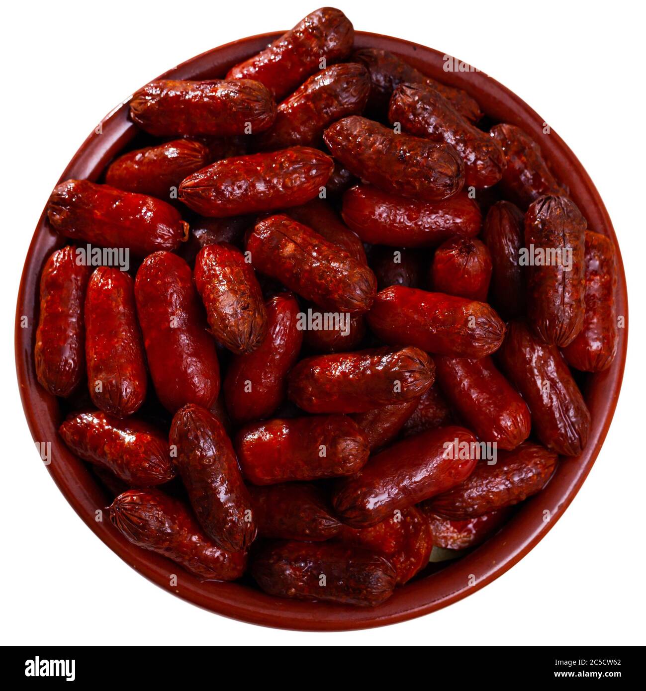 Spanish appetizer, warm mini chorizo sausages in ceramic bowl. Isolated ...