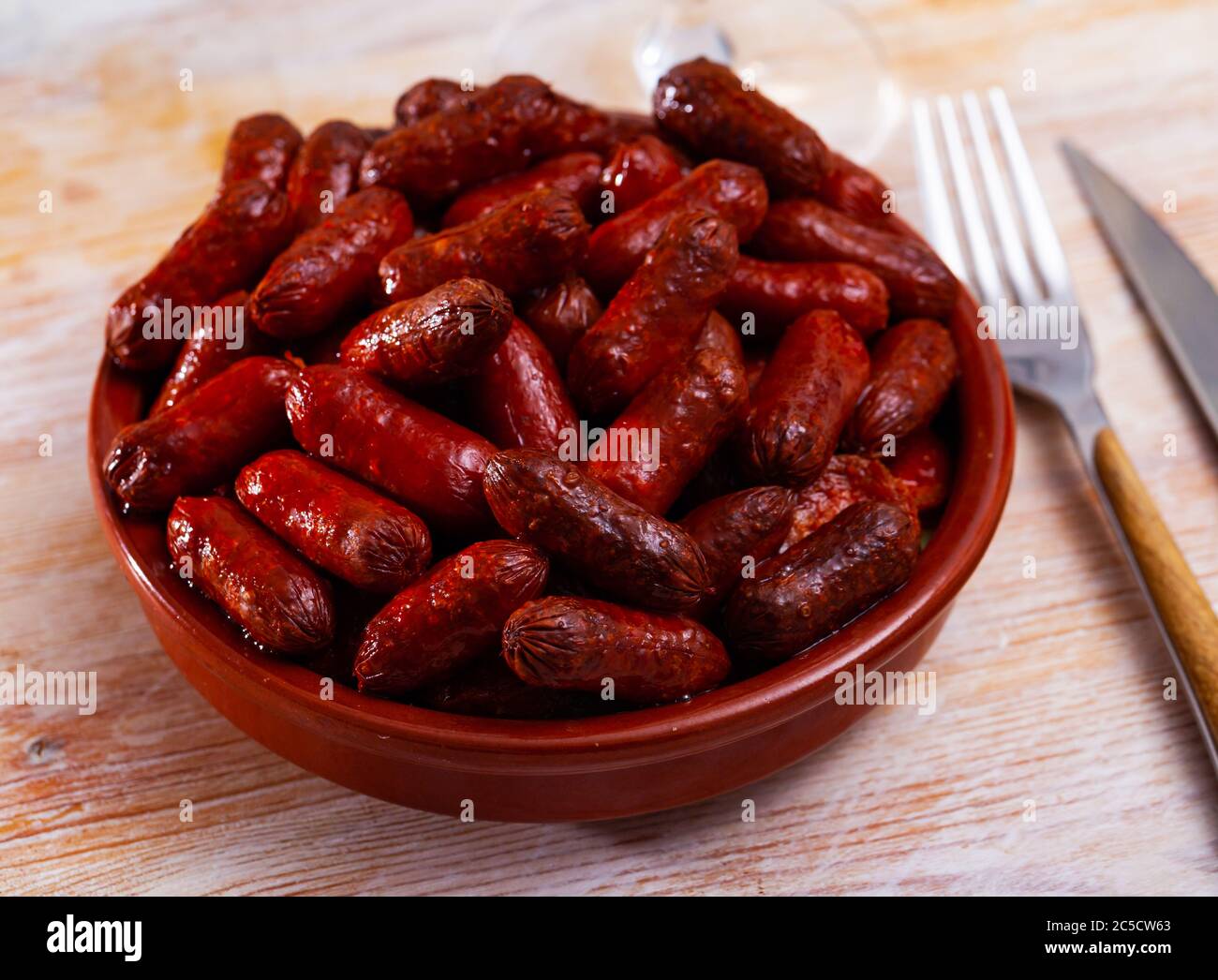 Mildly spiced grilled mini sausages chistorra. Favorite tapa from ...