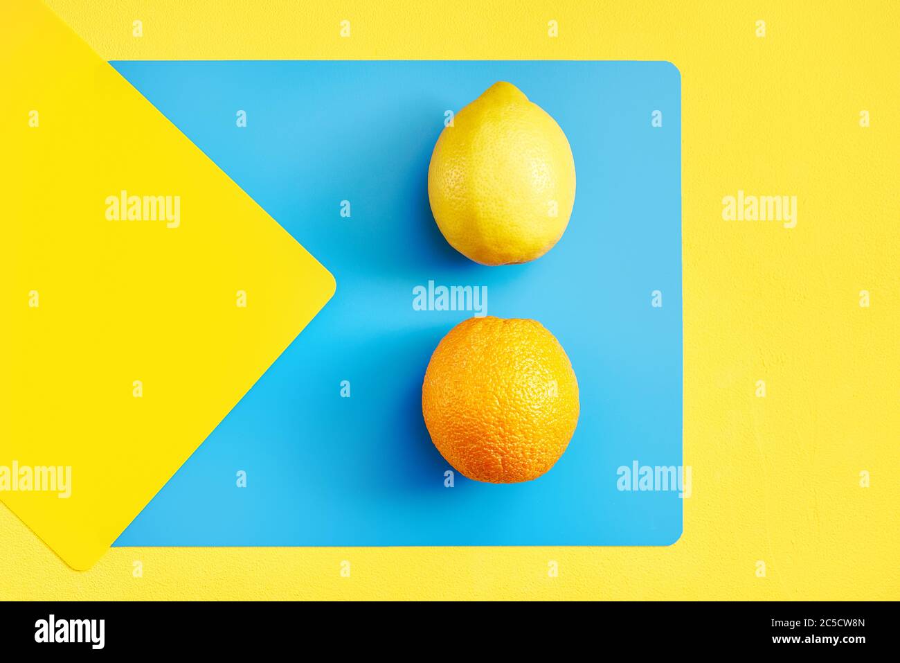 citrus fruits orange lemon on a blue yellow background Stock Photo - Alamy
