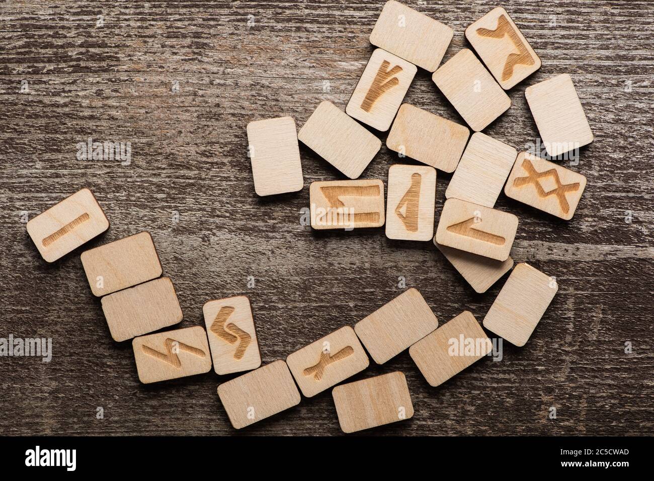 Top view of runes with symbols on wooden background Stock Photo - Alamy