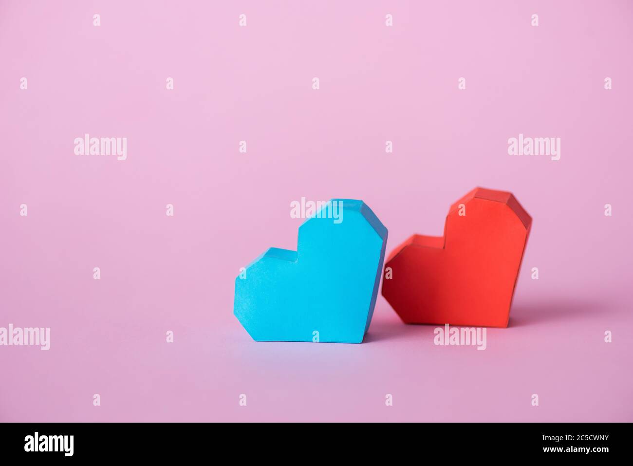 red and blue origami hearts on pink with copy space Stock Photo - Alamy