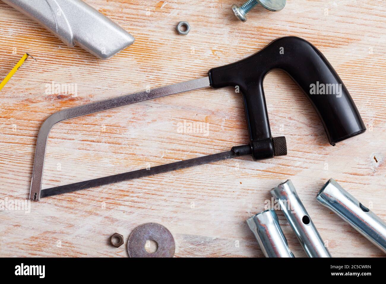 Top view of hacksaw surrounded by various tools on wooden table Stock ...