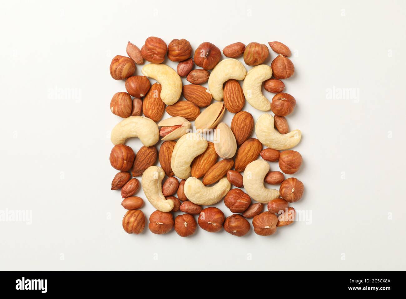 Different tasty nuts on white background. Vitamin food Stock Photo - Alamy
