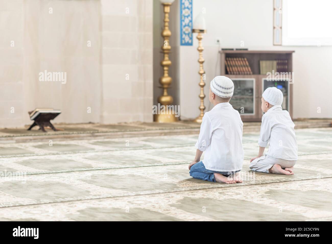 two Muslim boys are praying in a mosque Stock Photo - Alamy