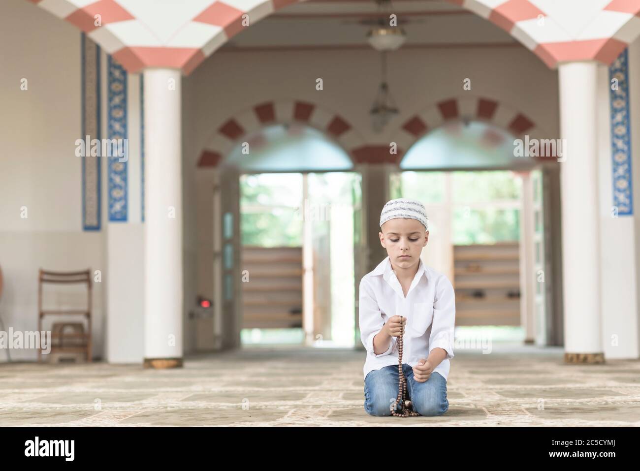 muslim boy prays in a mosque Stock Photo - Alamy
