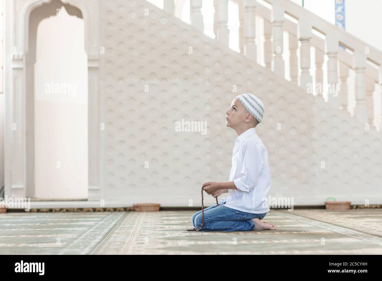 muslim boy prays in a mosque Stock Photo - Alamy