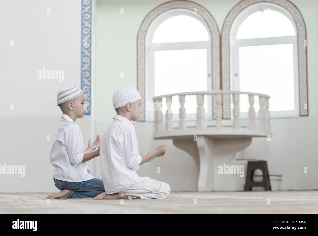 two Muslim boys are praying in a mosque Stock Photo - Alamy