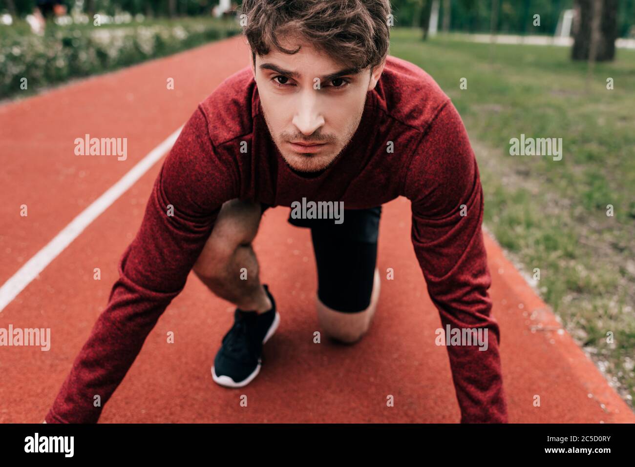 Man at running track in starting position hi-res stock photography and ...