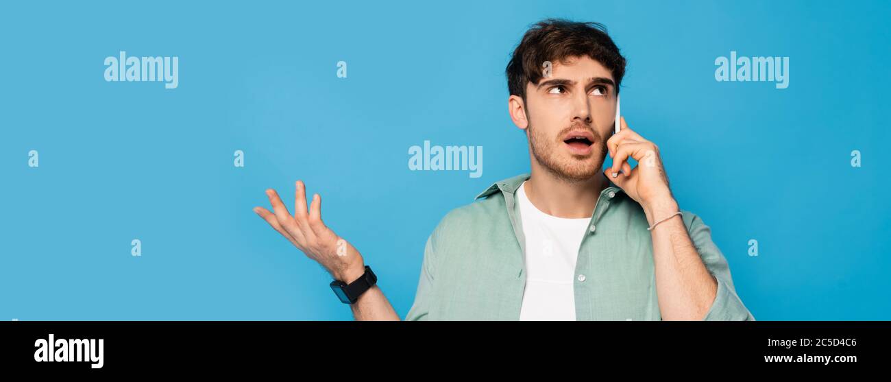 horizontal image of confused young man showing shrug gesture while ...