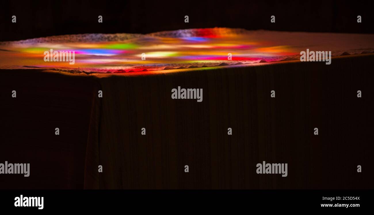 Faith concept. Colorful light spots on the altar cover in church ...