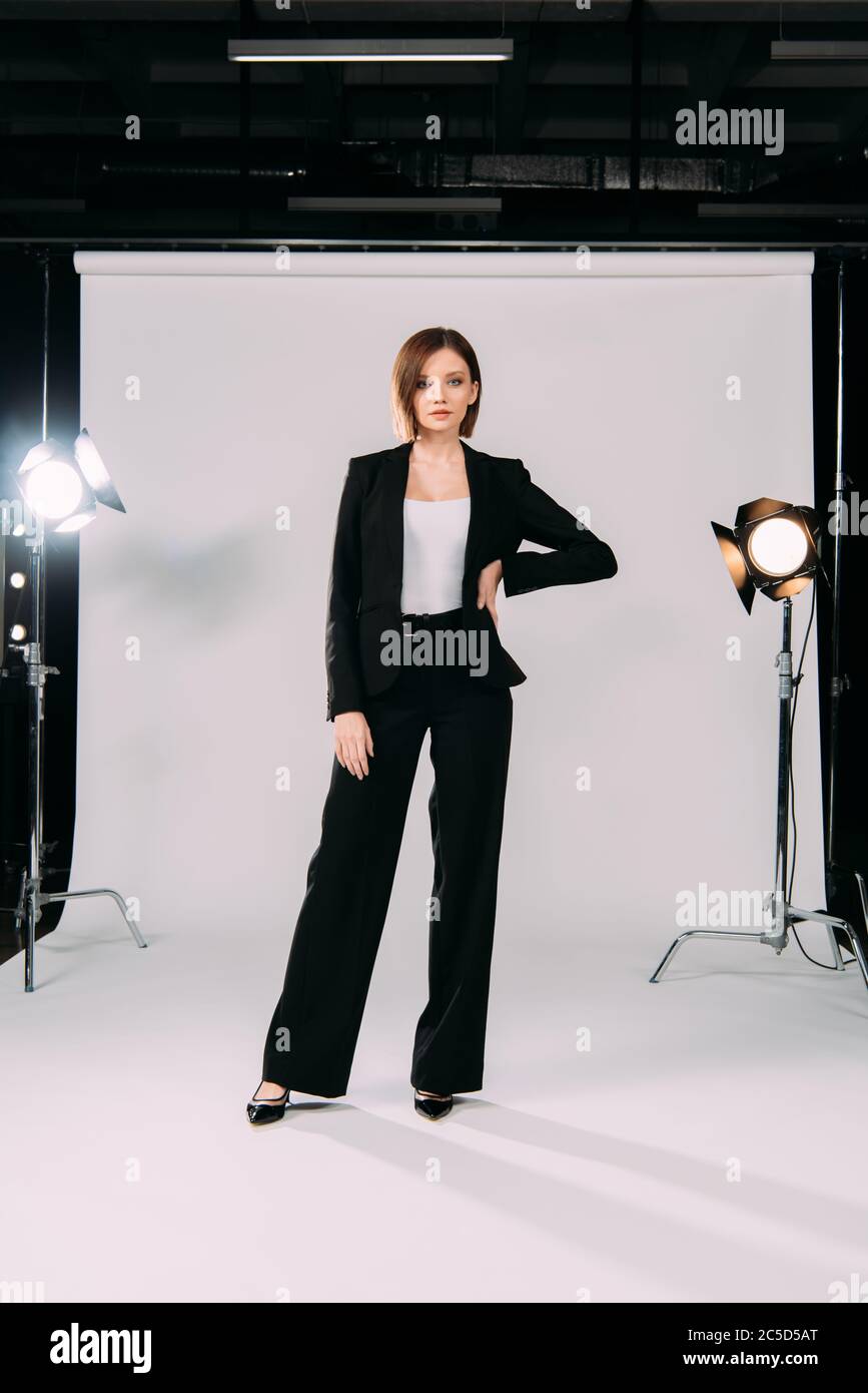 Beautiful elegant model with hand on hip looking at camera in photo ...