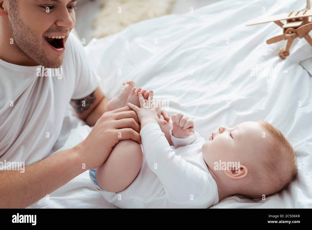 Boy touching legs hi-res stock photography and images - Alamy