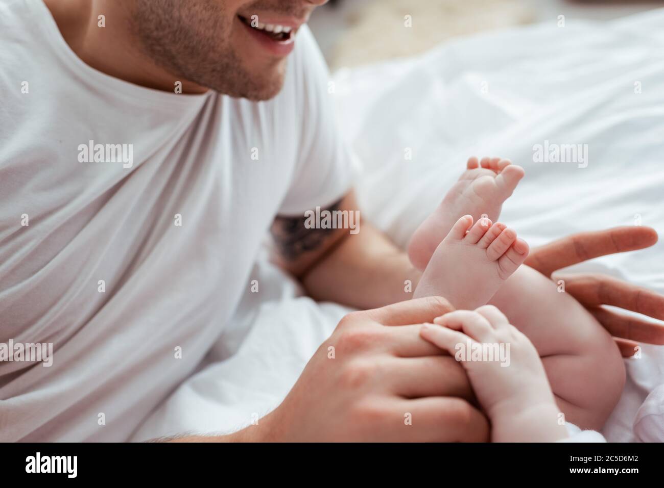 Boy touching legs hi-res stock photography and images - Alamy