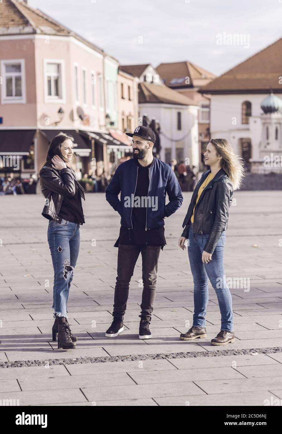 group of young people stand on the street and talk Stock Photo - Alamy
