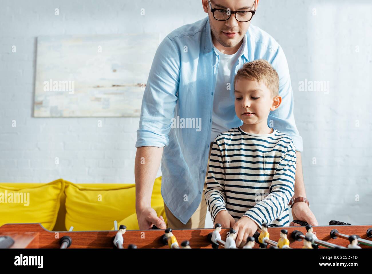 attentive father and son playing table football at home Stock Photo - Alamy