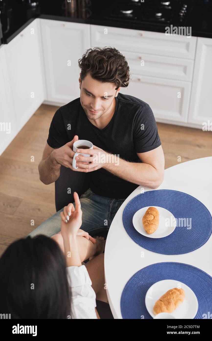 Overhead view of woman flirting with handsome boyfriend during ...