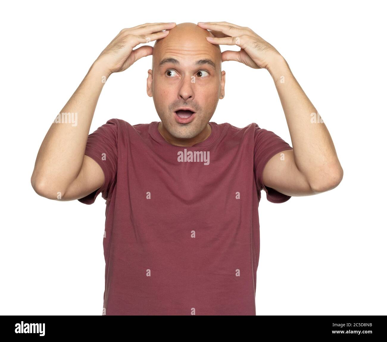 surprised bald man holds his head in hands and looking aside. Isolated ...