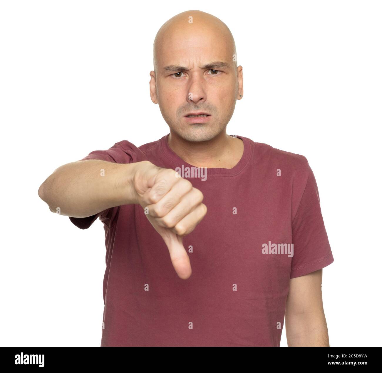 Serious bald man showing his thumb down. Isolated Stock Photo - Alamy