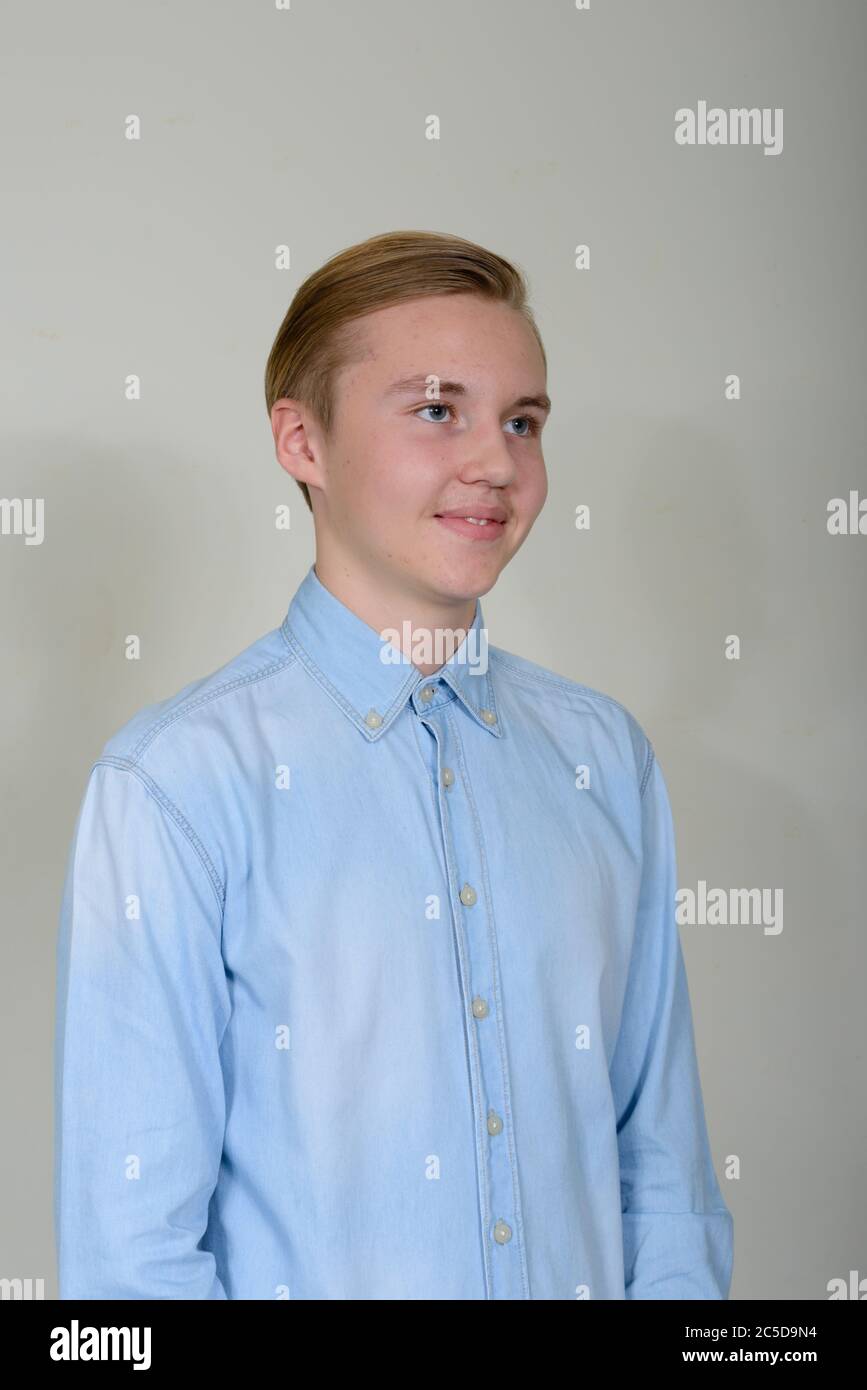 Portrait of happy young handsome blond teenage boy thinking Stock Photo ...