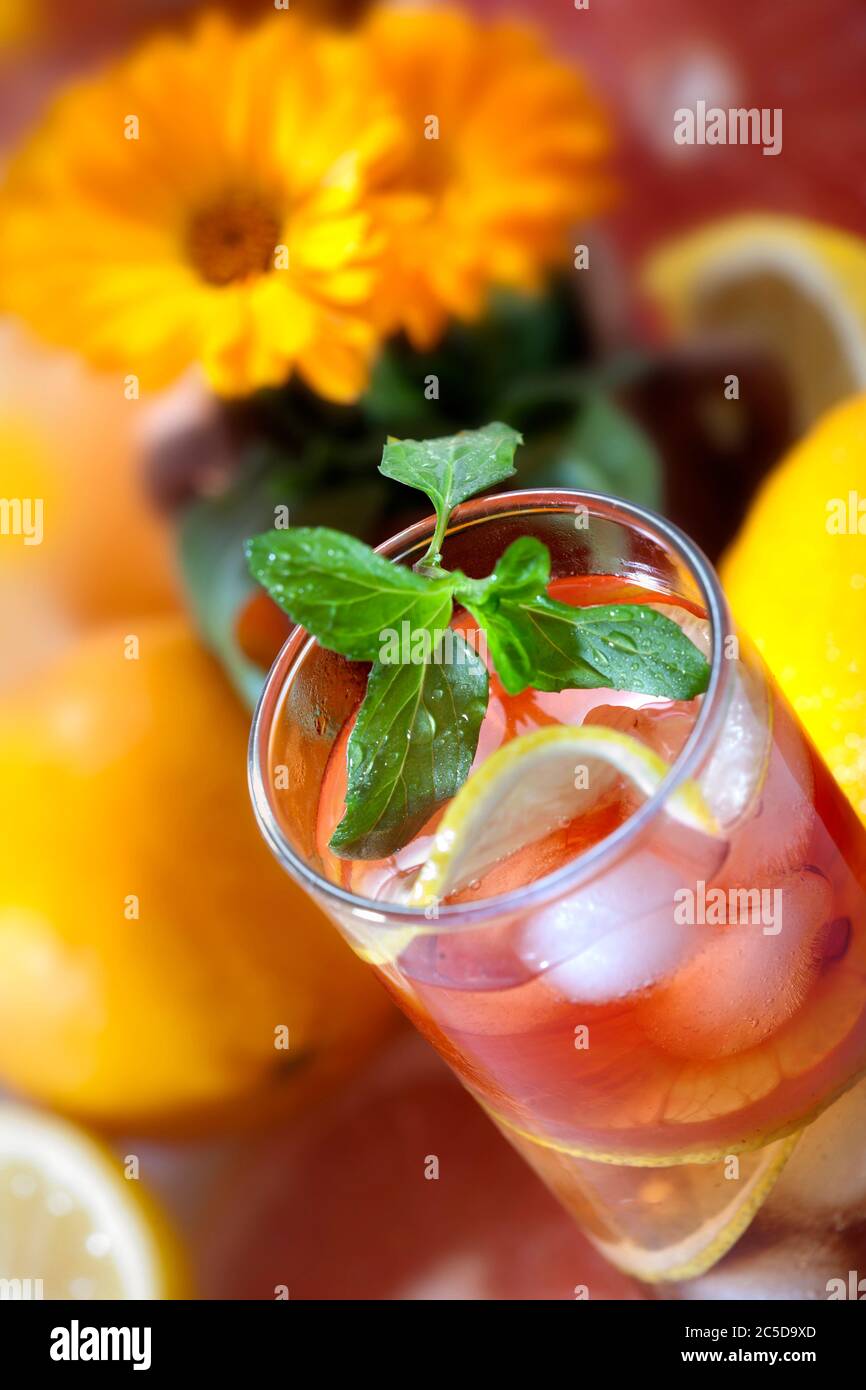 Fresh and cold ice tea with sliced orange, grapefruit, lemon, and mint ...