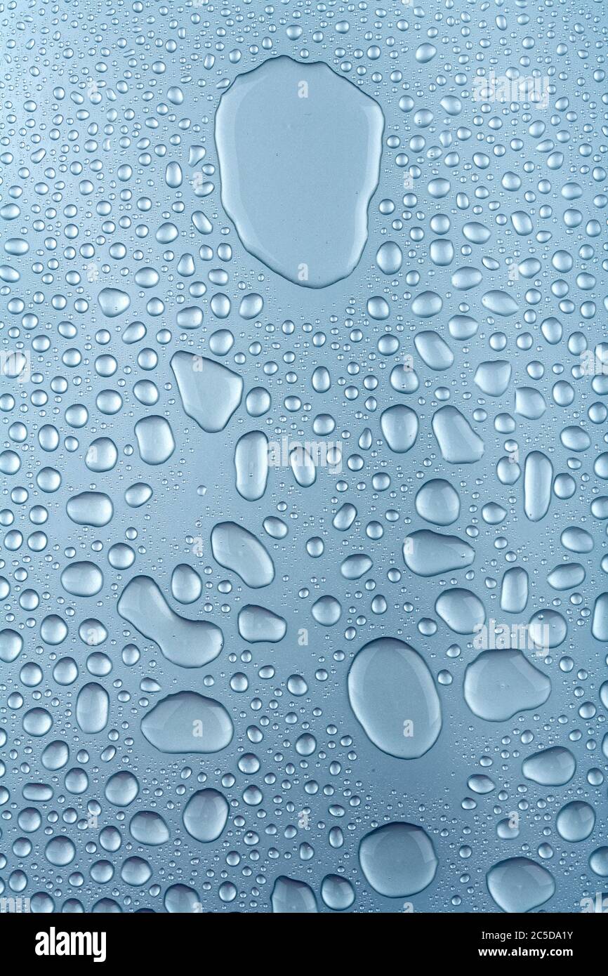 Drops of water on a light blue background. Metallic surface with water ...