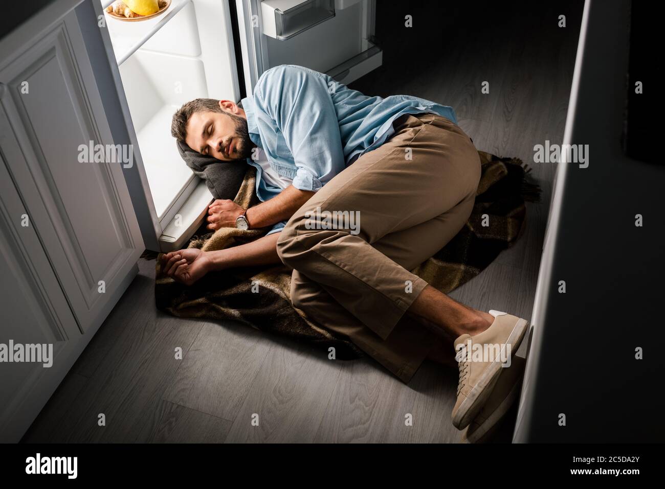 Handsome man sleeping near open fridge in kitchen at night Stock Photo ...