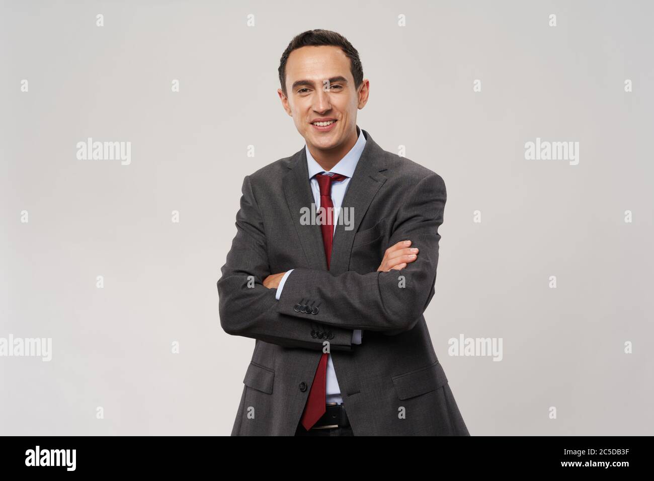 Business man crossed his arms over his chest or looking at the camera ...