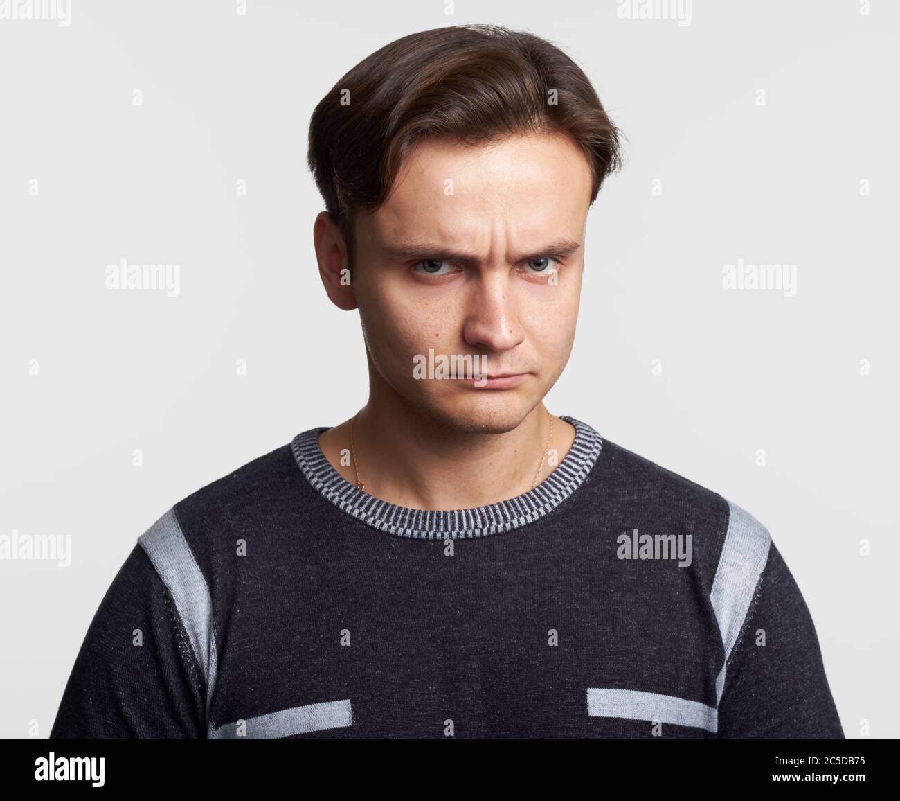 angry man looking at camera. Isolated on gray studio background Stock ...