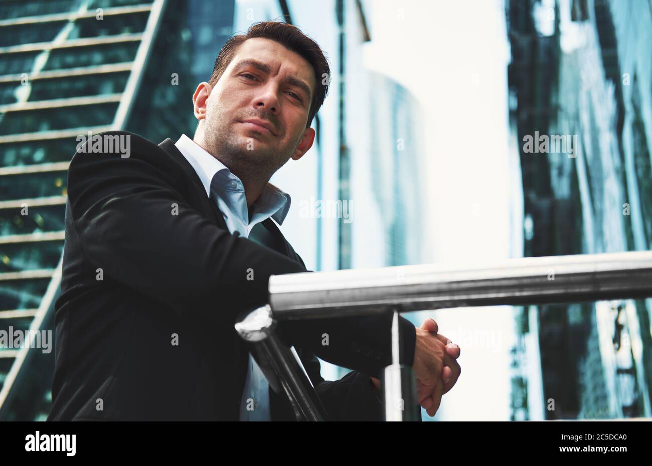 Confident office worker on a street. Outdoors portrait of handsome ...