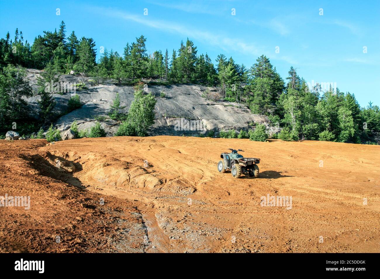 Quad ATV stands on sandy terrain at a beautiful lake Stock Photo - Alamy