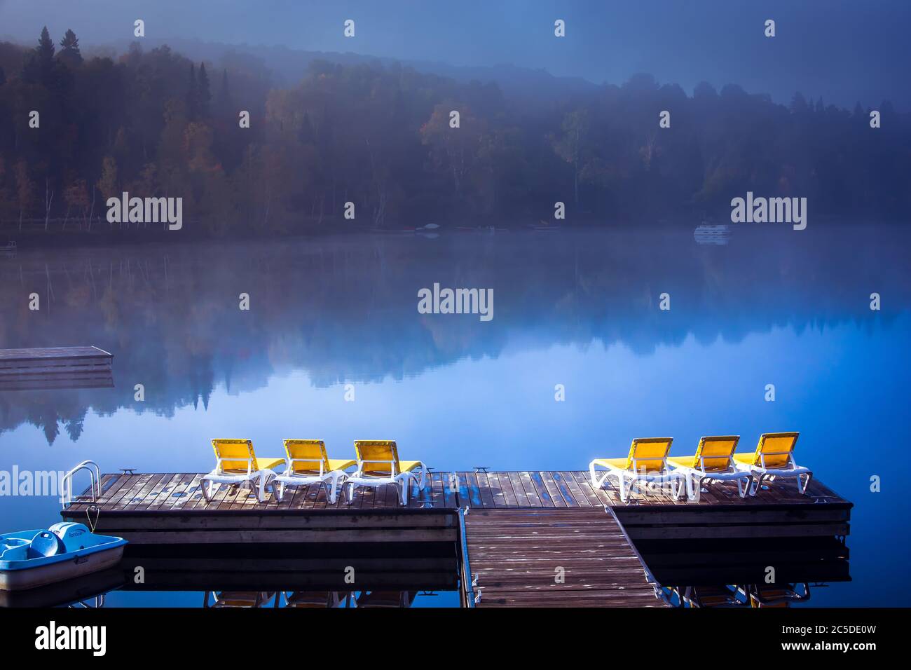 view of a boat dock the Lac-Superieur, misty morning with fog, in ...