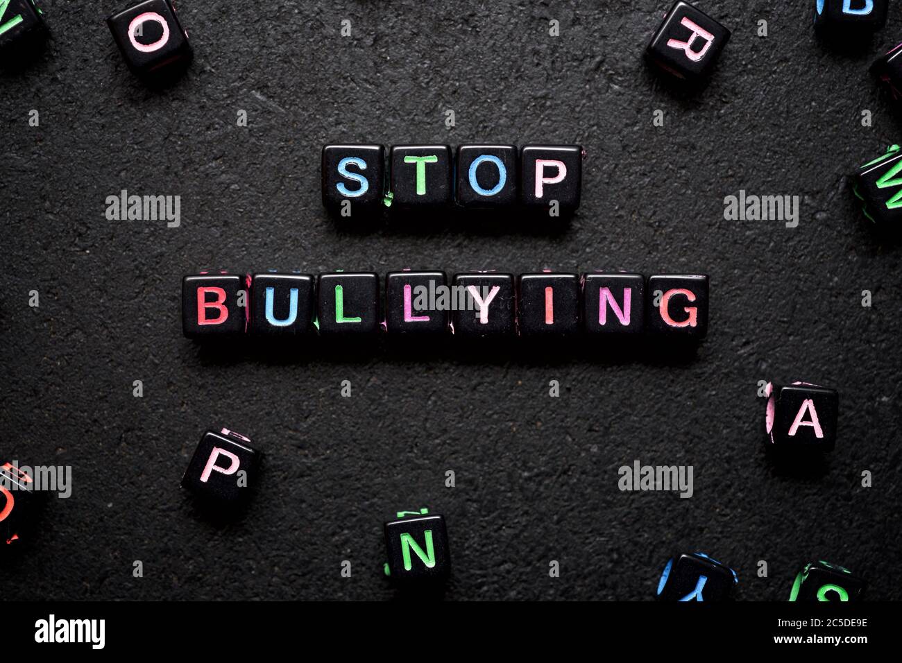 Stop bullying sentence on a black table Stock Photo - Alamy