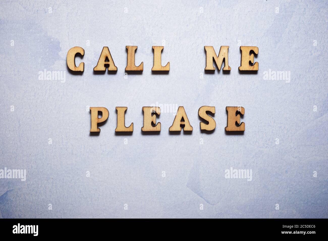 Call me Please text in a colored paper Stock Photo - Alamy