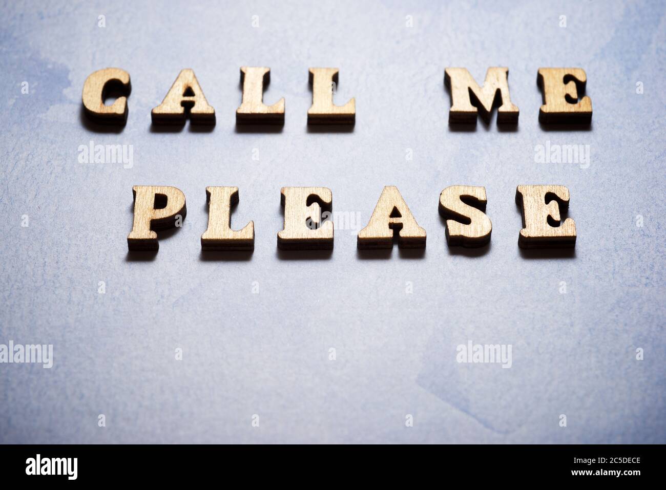 Call me Please text in a colored paper Stock Photo - Alamy