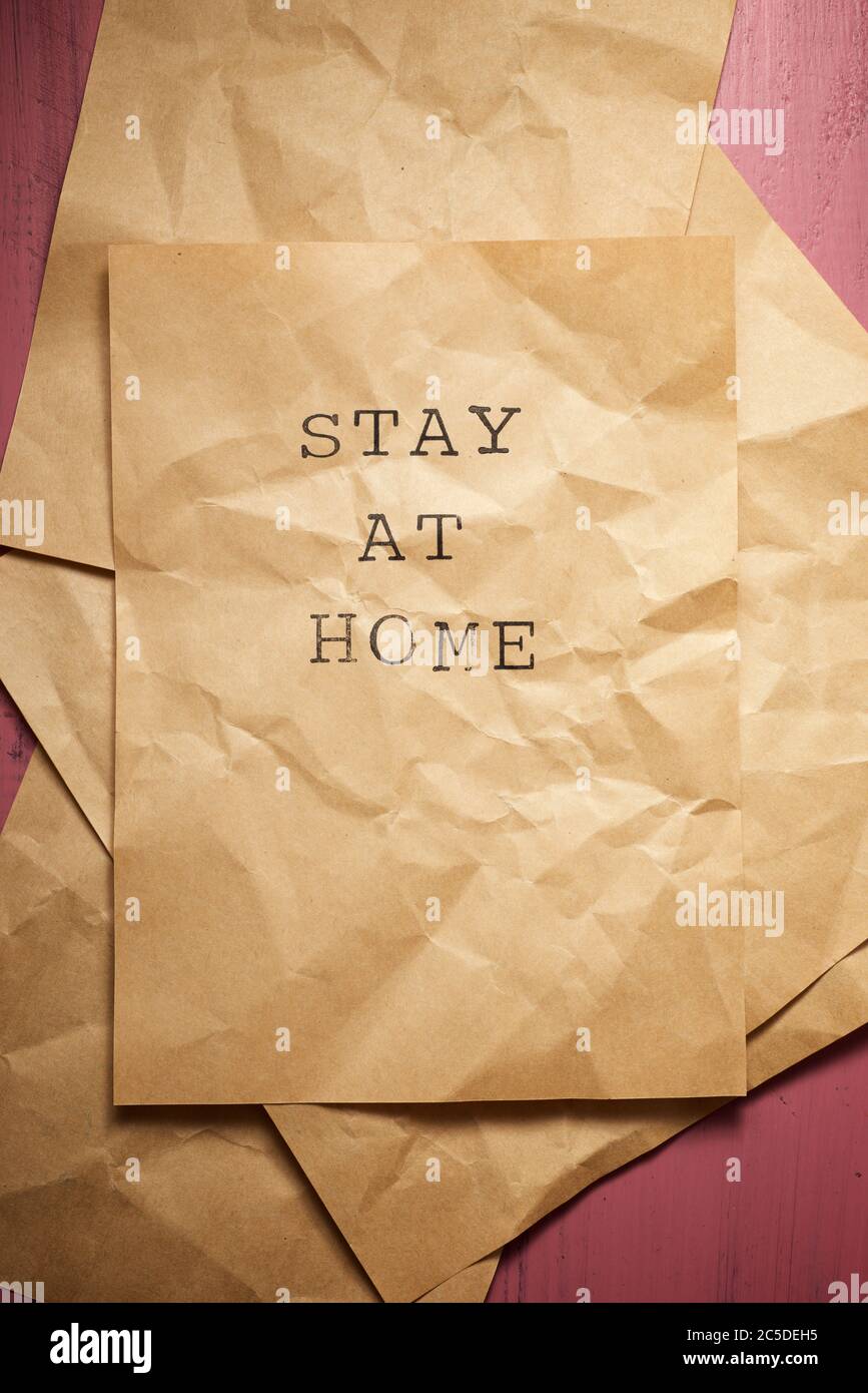 Stay at Home text on a brown paper Stock Photo - Alamy