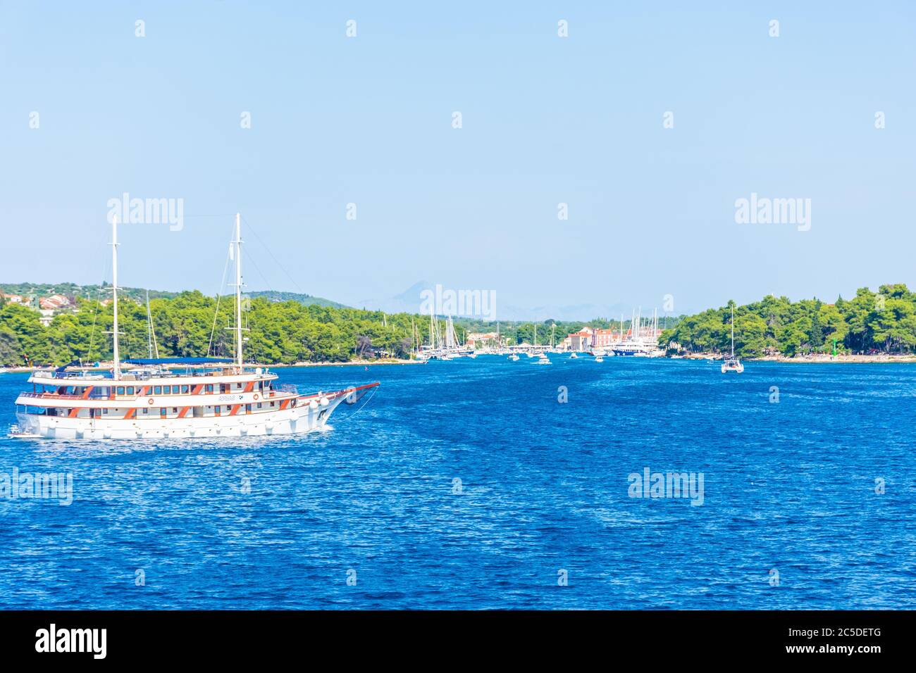 Boat sailing toward the harbor of Stari Grad, Hvar island, Croatia ...