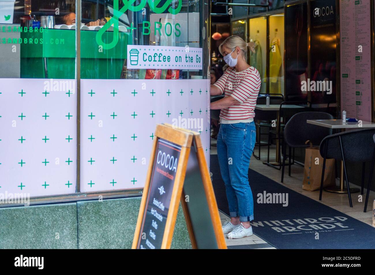 Cork, Ireland. 2nd July, 2020. A woman wears a face mask in Cork city ...