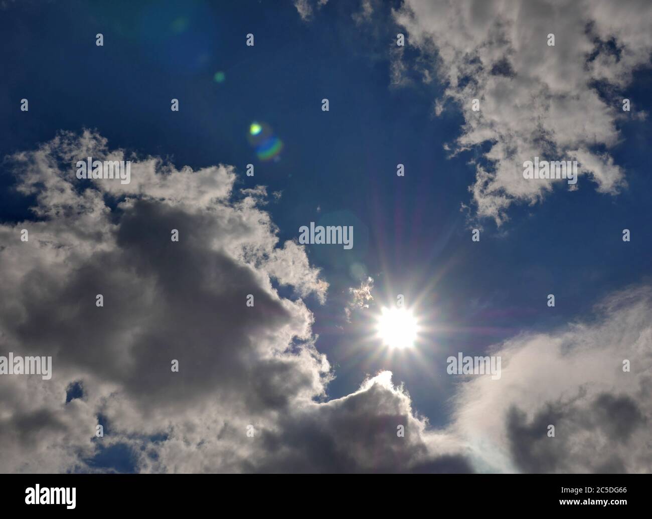 clouds blue sky sun light ray beam Stock Photo - Alamy
