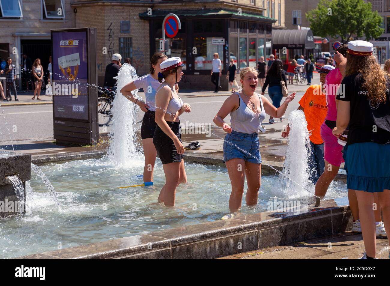 Dansih high school students playing in a fountain celebrating ...