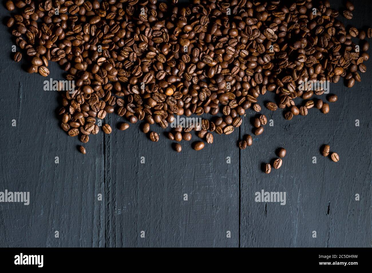 Coffee beans raining from top of rustic wooden plank background with ...