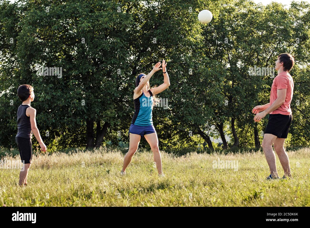 Children throwing ball together hi-res stock photography and images - Alamy