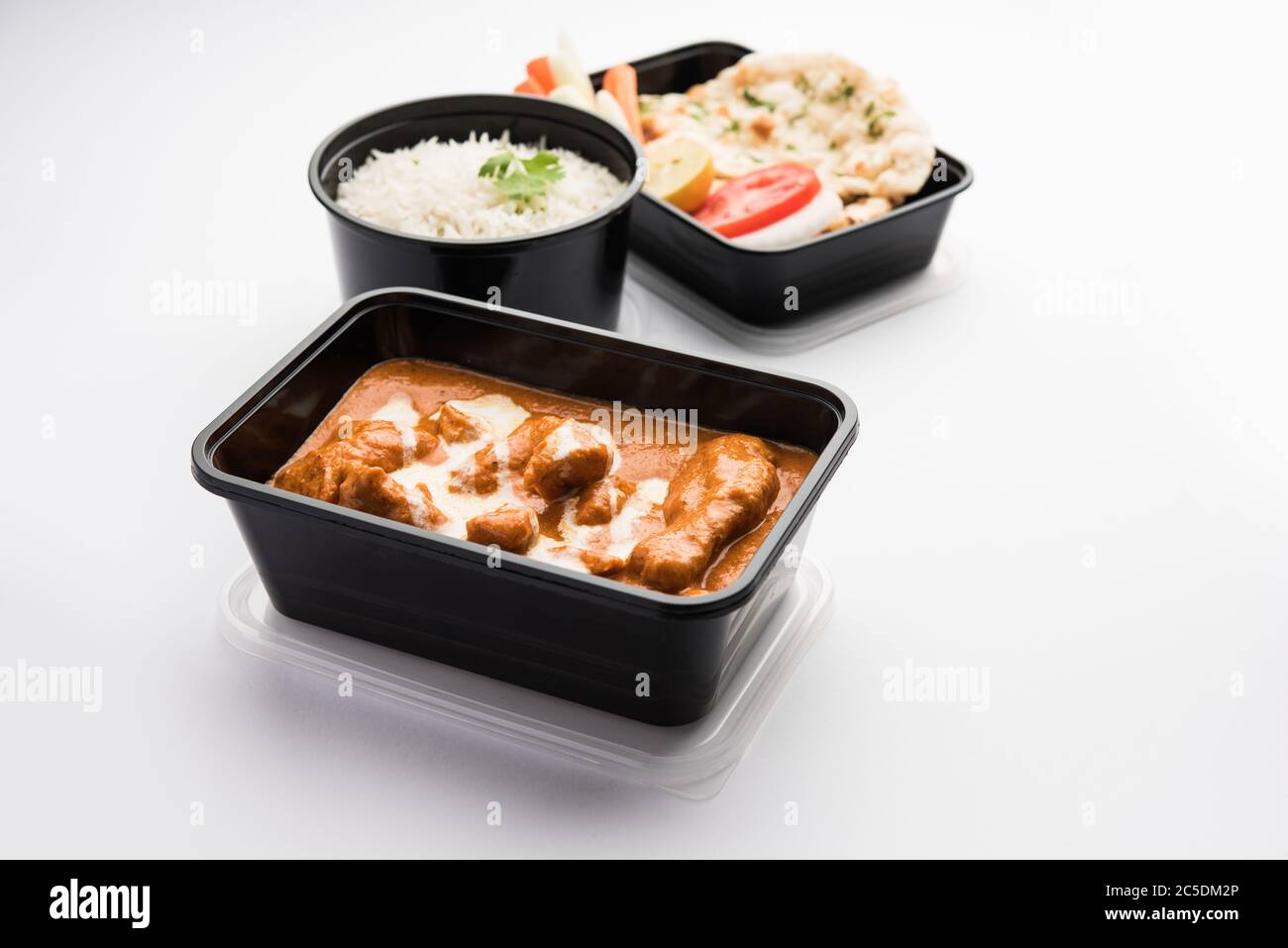 Indian butter chicken curry dish served in black plastic container for ...