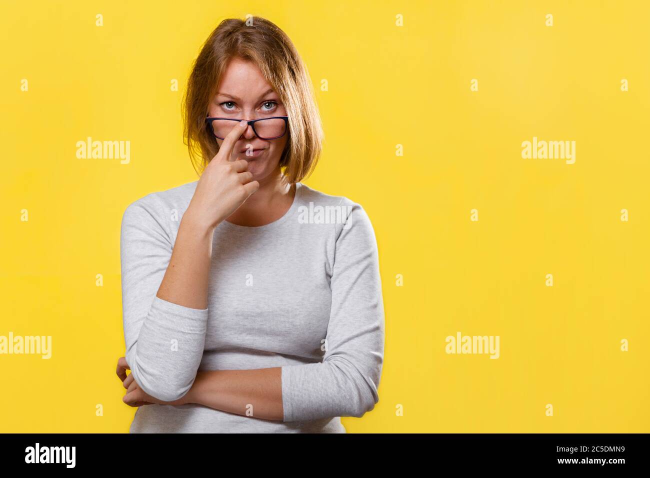 Emotions And Psychology A Blonde Woman With Glasses Thoughtfully
