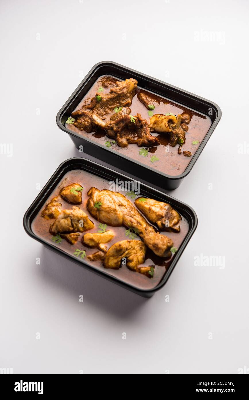 Red Chicken Curry and Mutton Masala packed in a plastic container for ...