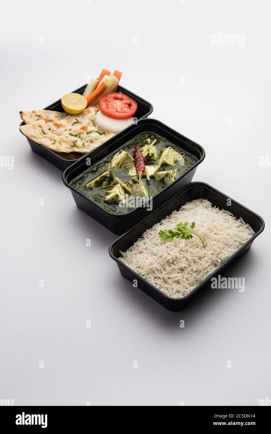 Palak Paneer with rice and chapati packed in a plastic container ready ...