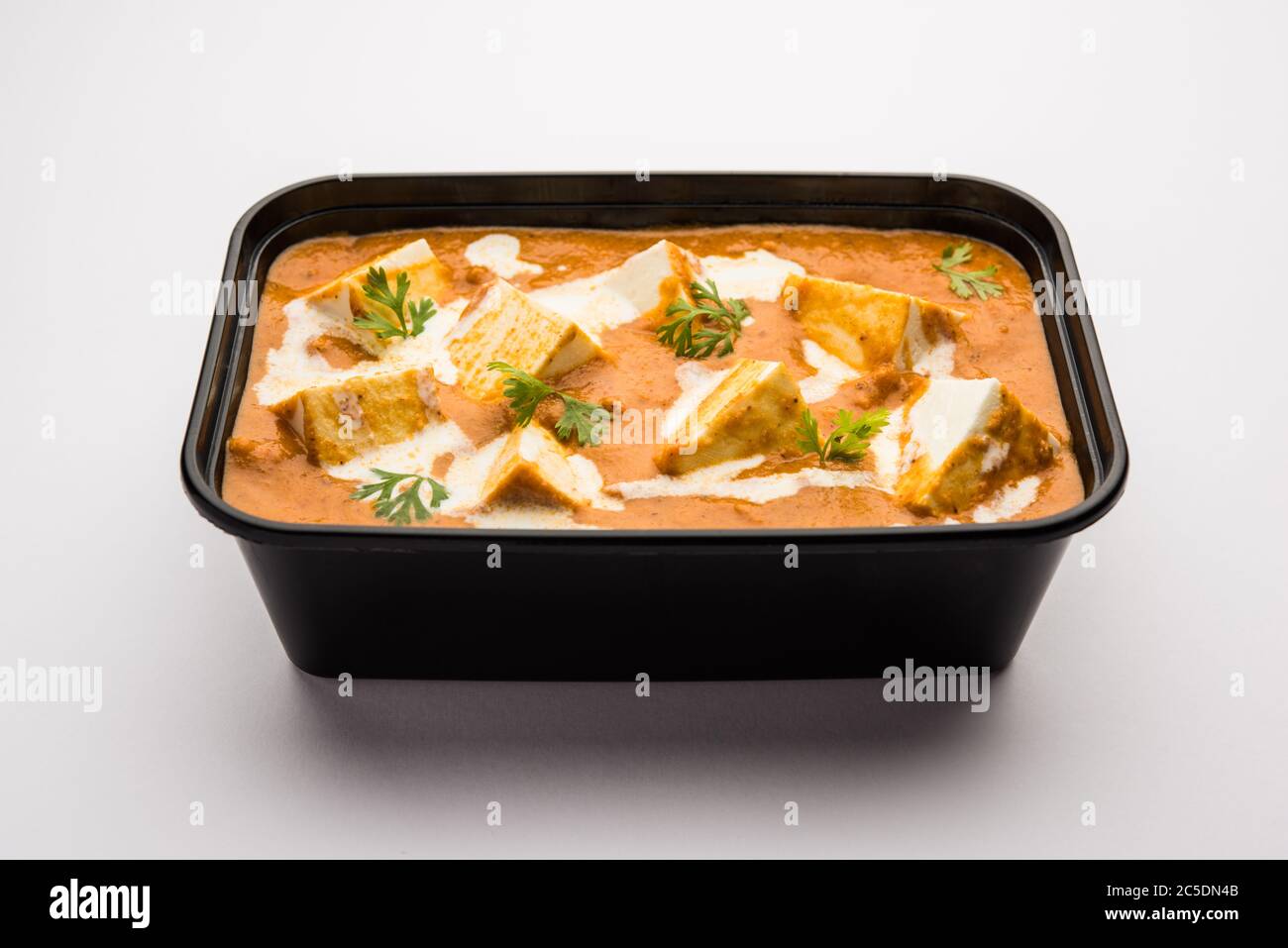 Paneer Butter Masala packed in plastic container or box, ready for home ...