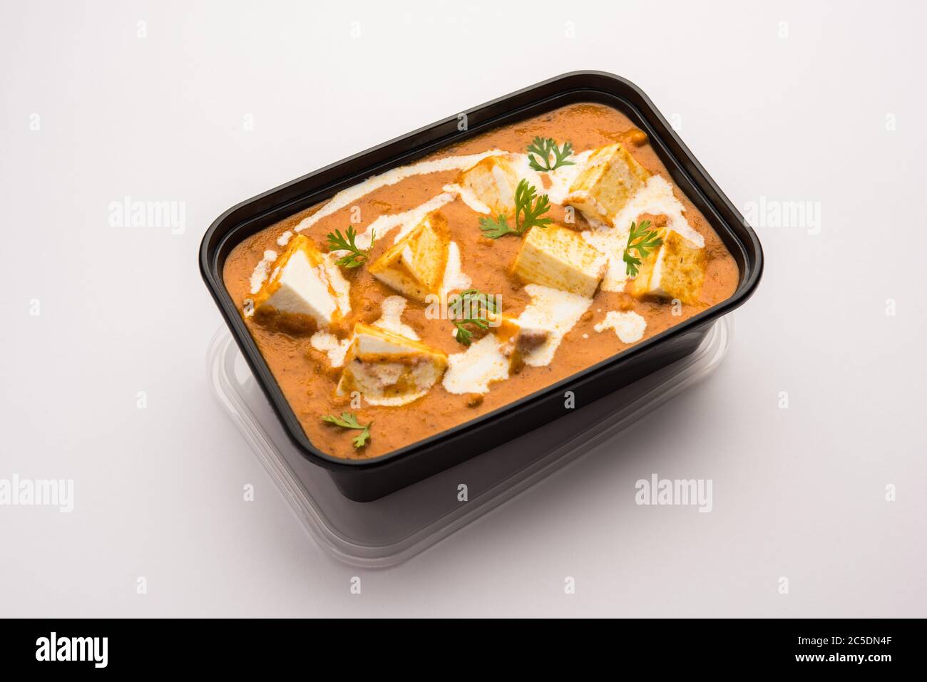 Paneer Butter Masala packed in plastic container or box, ready for home ...